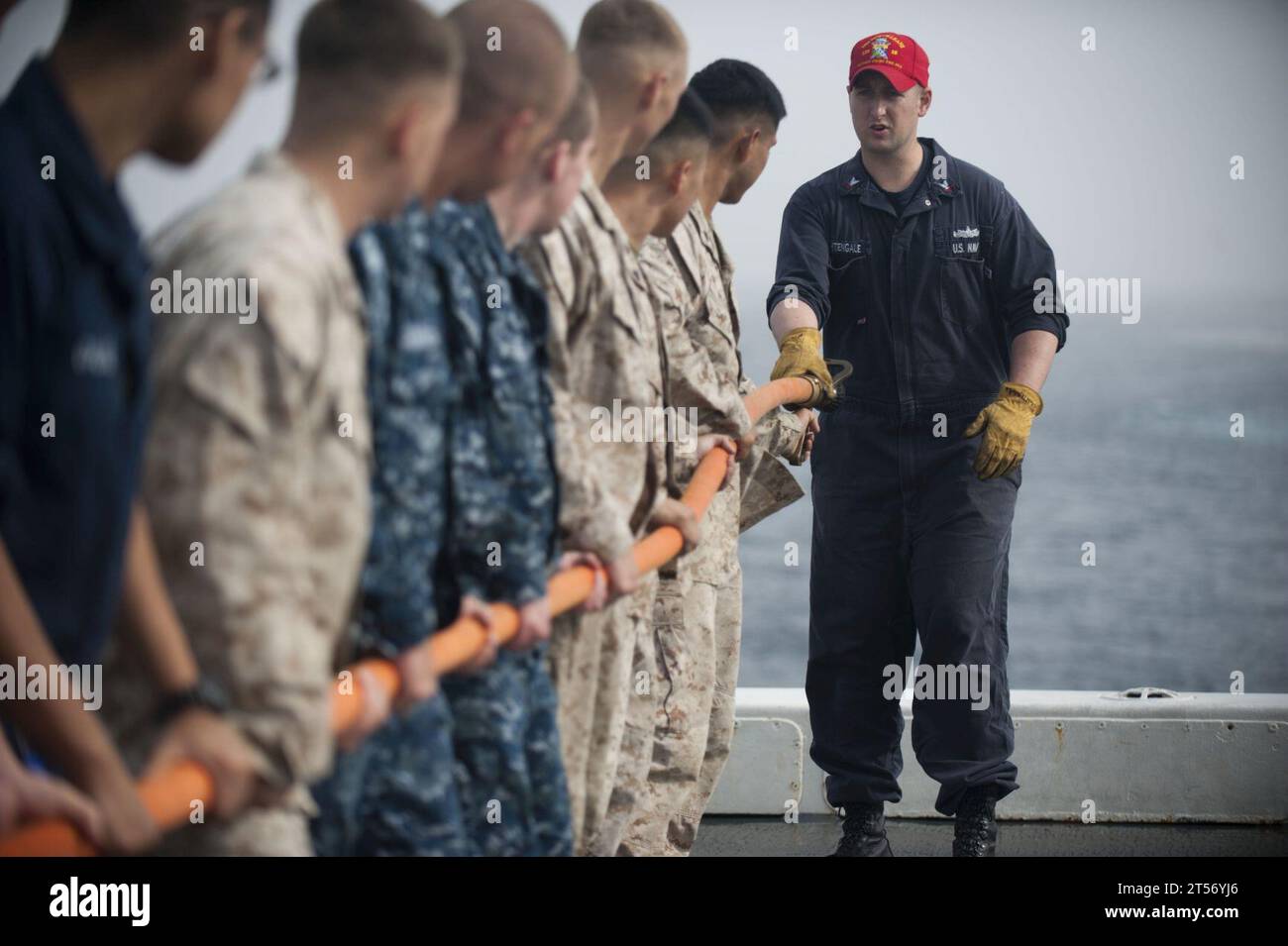 US Navy A Sailor demonstrates how to properly handle a hose during a ...