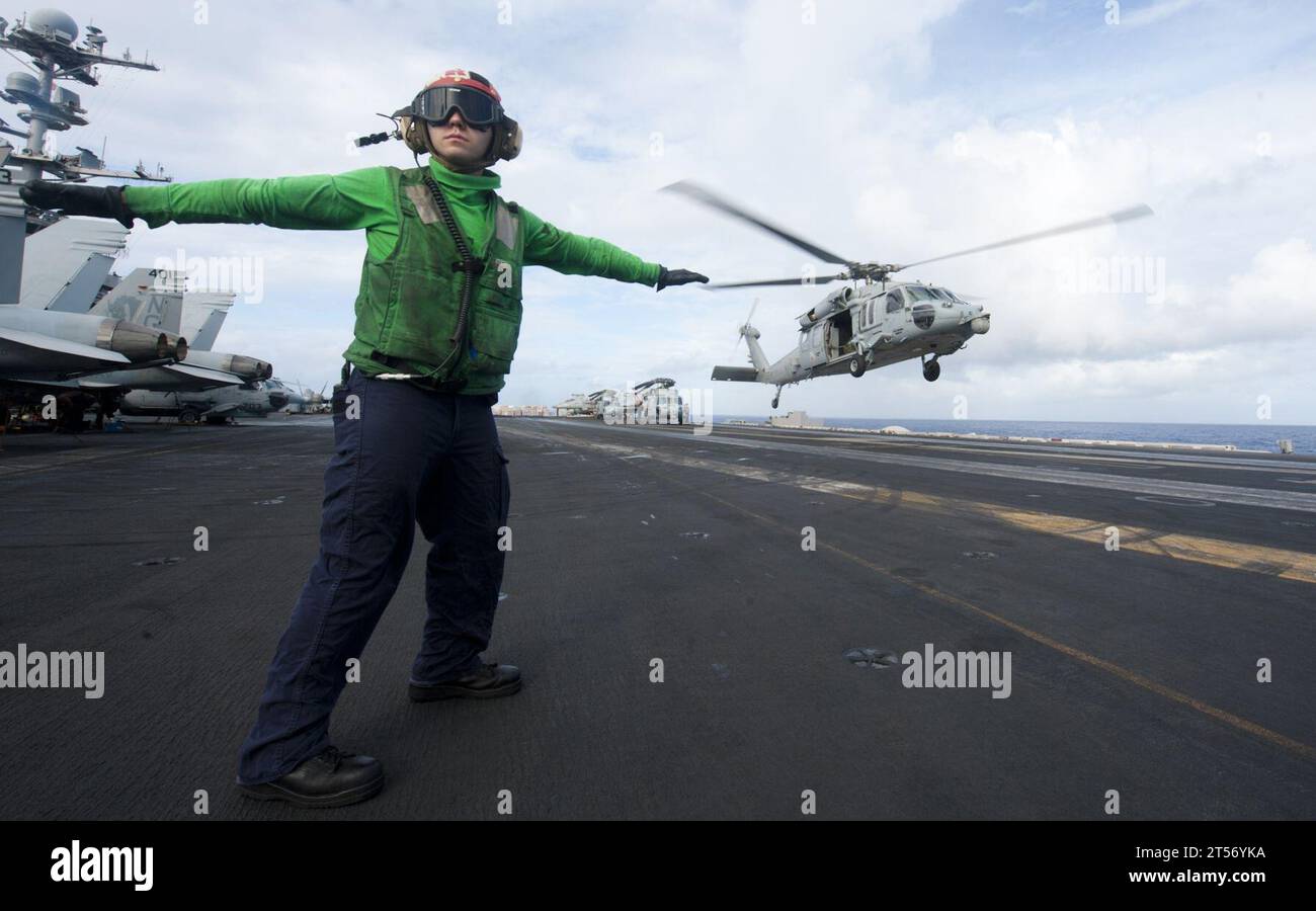 US Navy A Sailor directs an MH-60S Sea Hawk helicopter from the ...