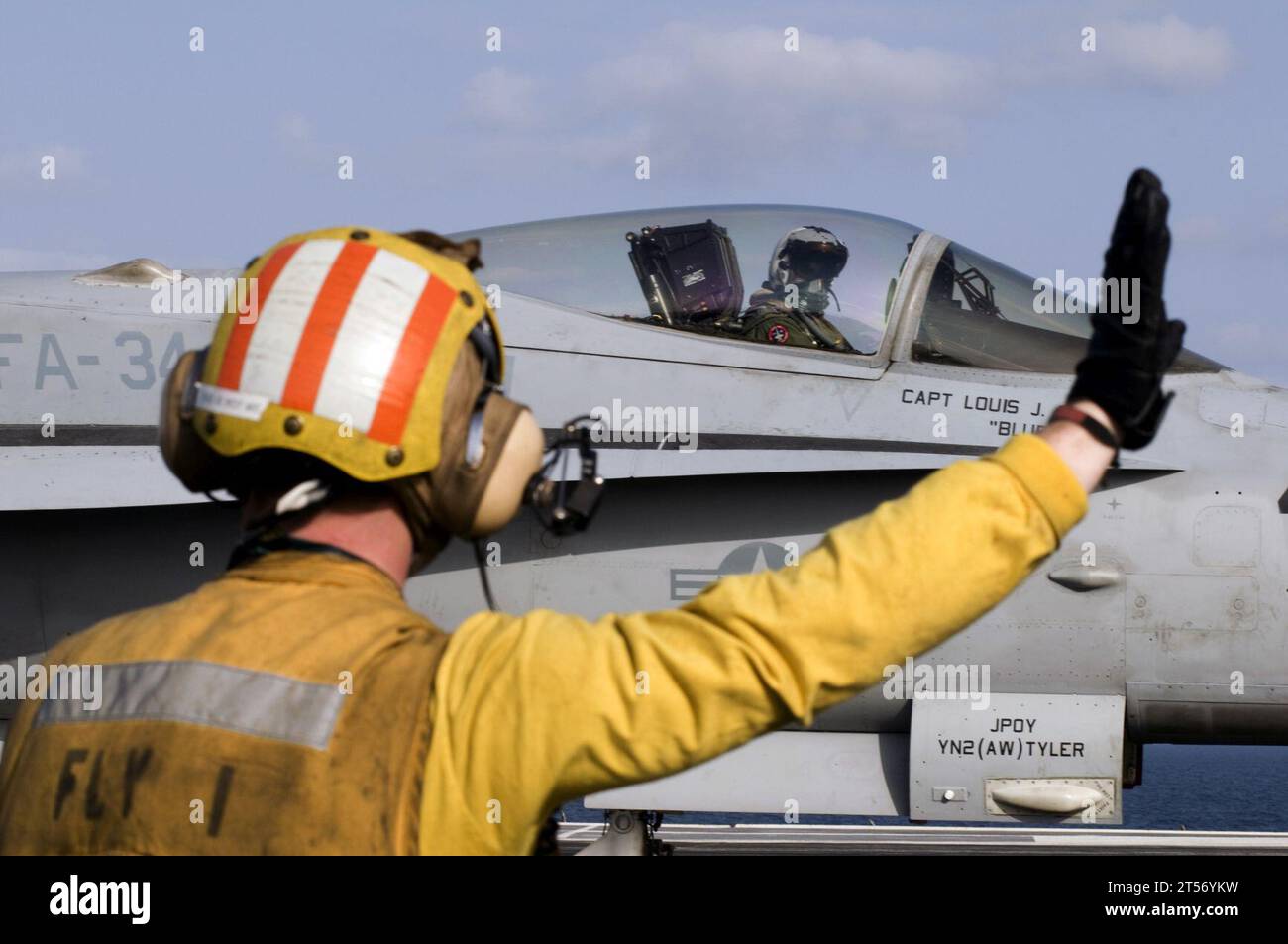 US Navy A Sailor directs the pilot of an F18C Hornet assigned to the ...