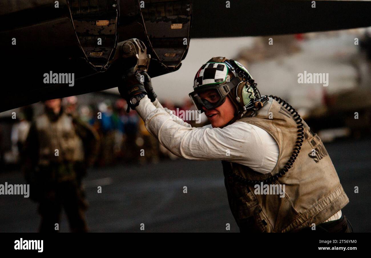 US Navy A Sailor checks the tail hook of an F18F Super Hornet from the ...