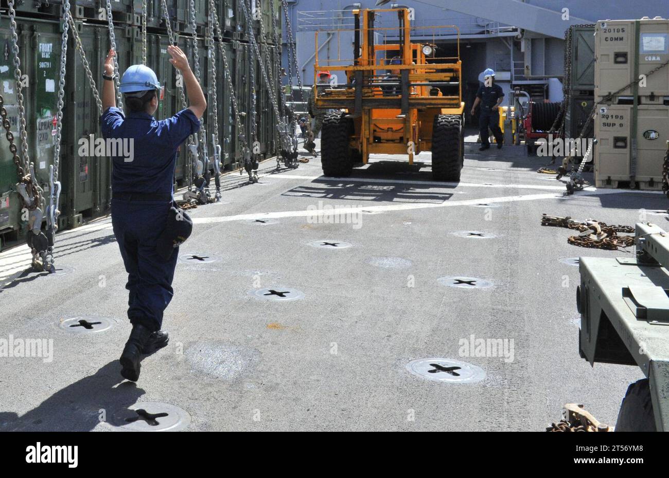 US Navy A Sailor directs a forklift aboard the amphibious dock landing ...