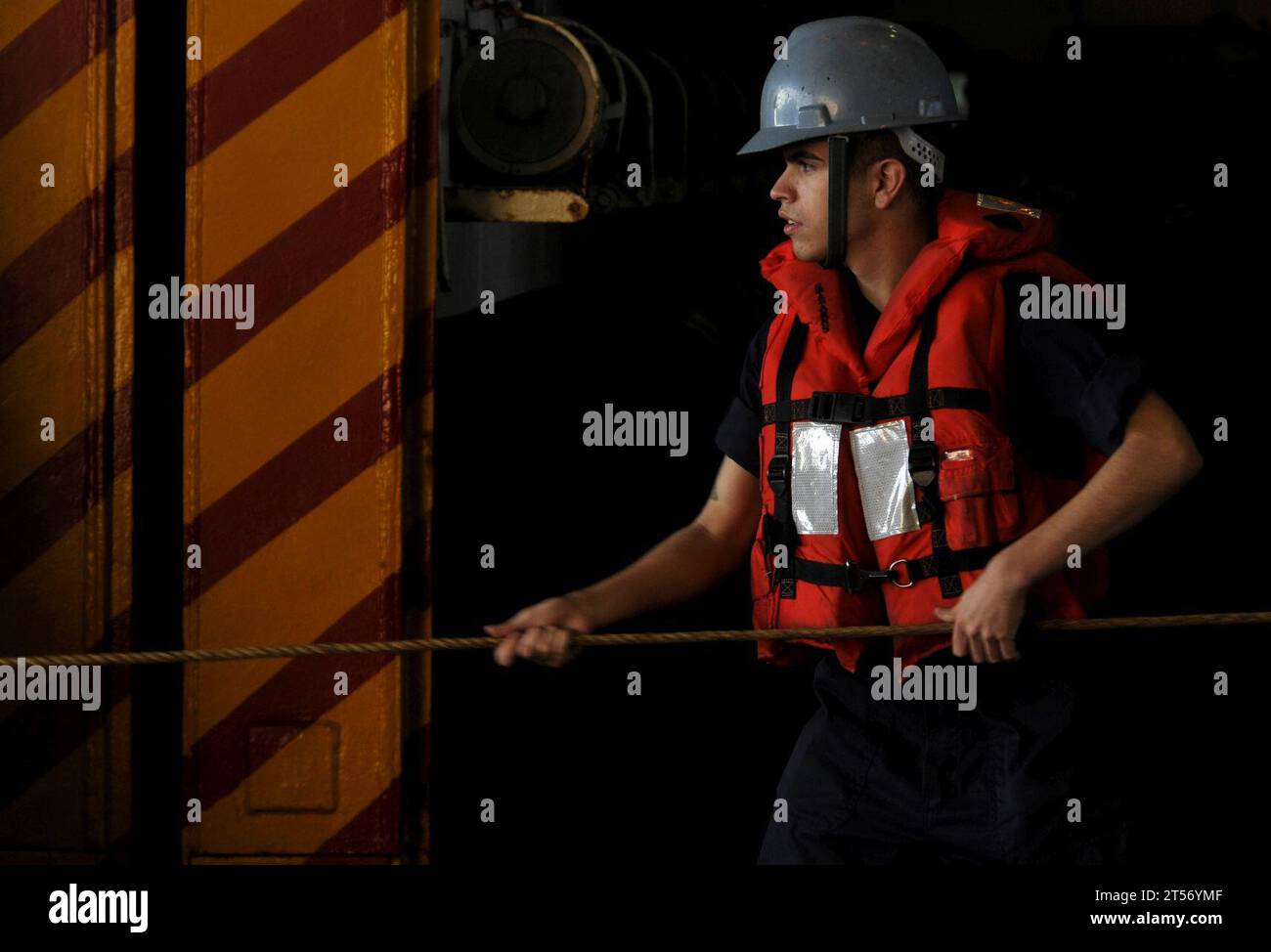 US Navy A Sailor brings in the messenger line during a replenishment at ...