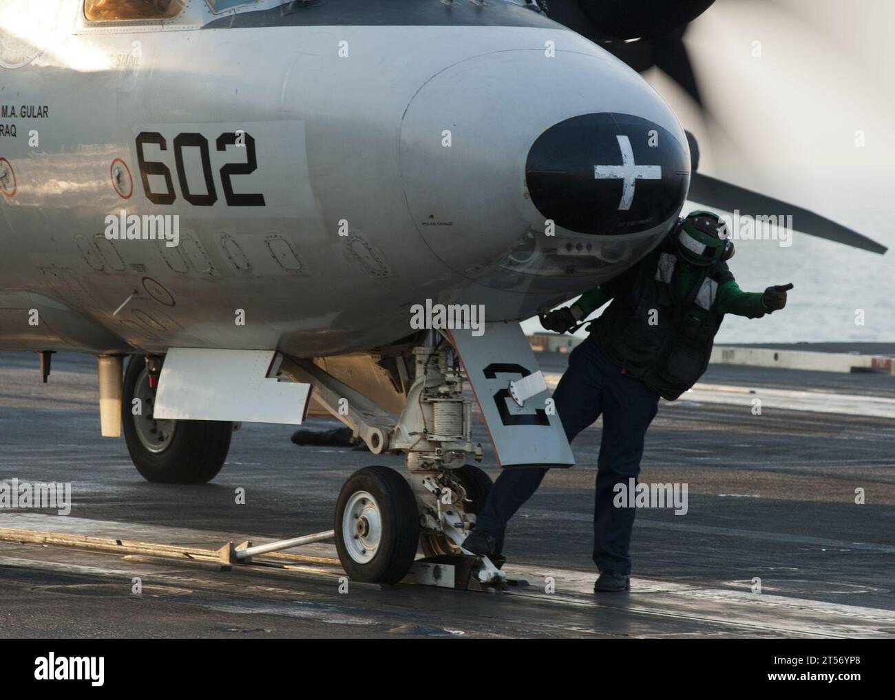 US Navy A Sailor gives the signal to add tension to the catapult to ...
