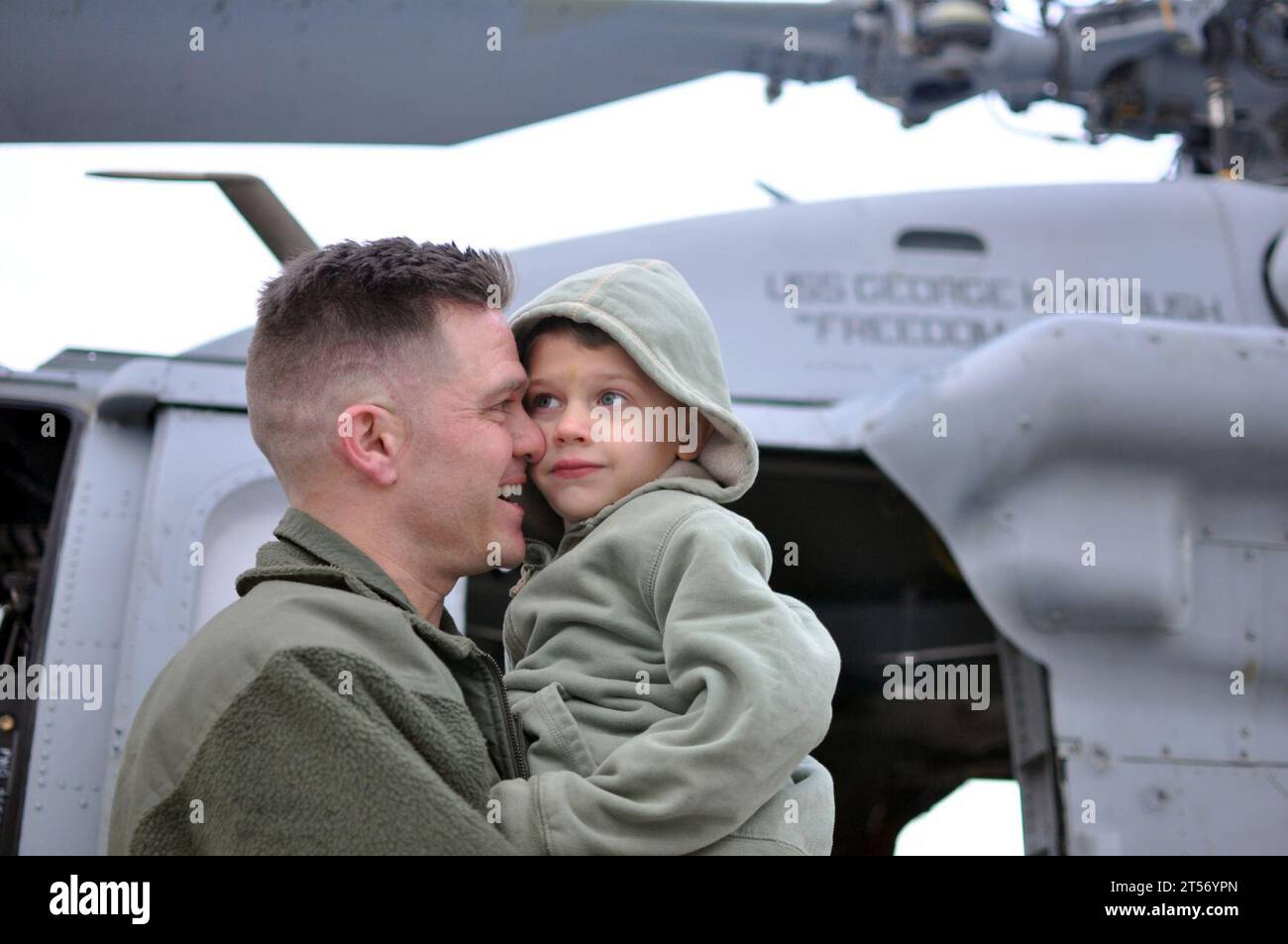 US Navy A Sailor hugs his son during the squadron's homecoming ceremony ...