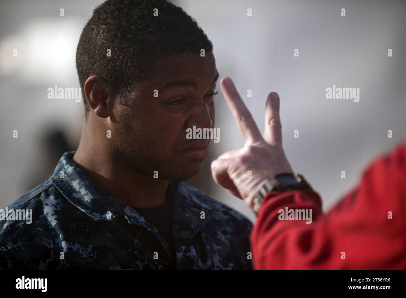 US Navy A Sailor holds up fingers to test vision.jpg Stock Photo - Alamy