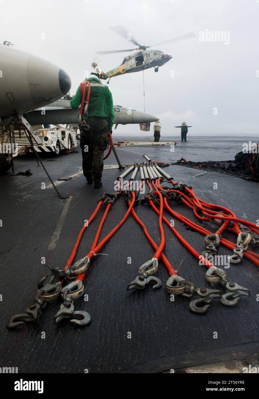 US Navy A Sailor organizes cargo hooks on the flight deck of the Nimitz ...
