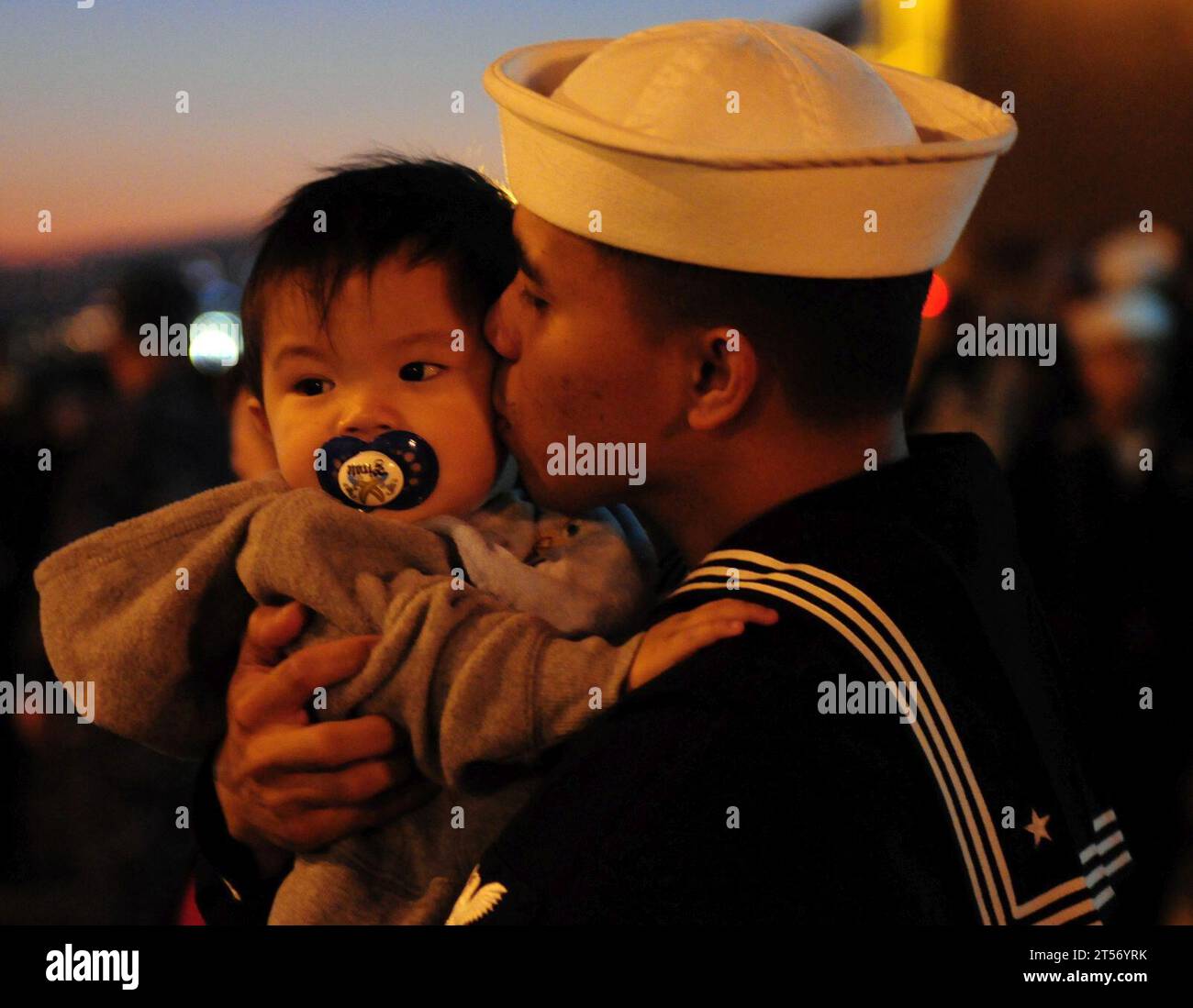 US Navy A Sailor kisses his son goodbye before the Nimitz-class ...