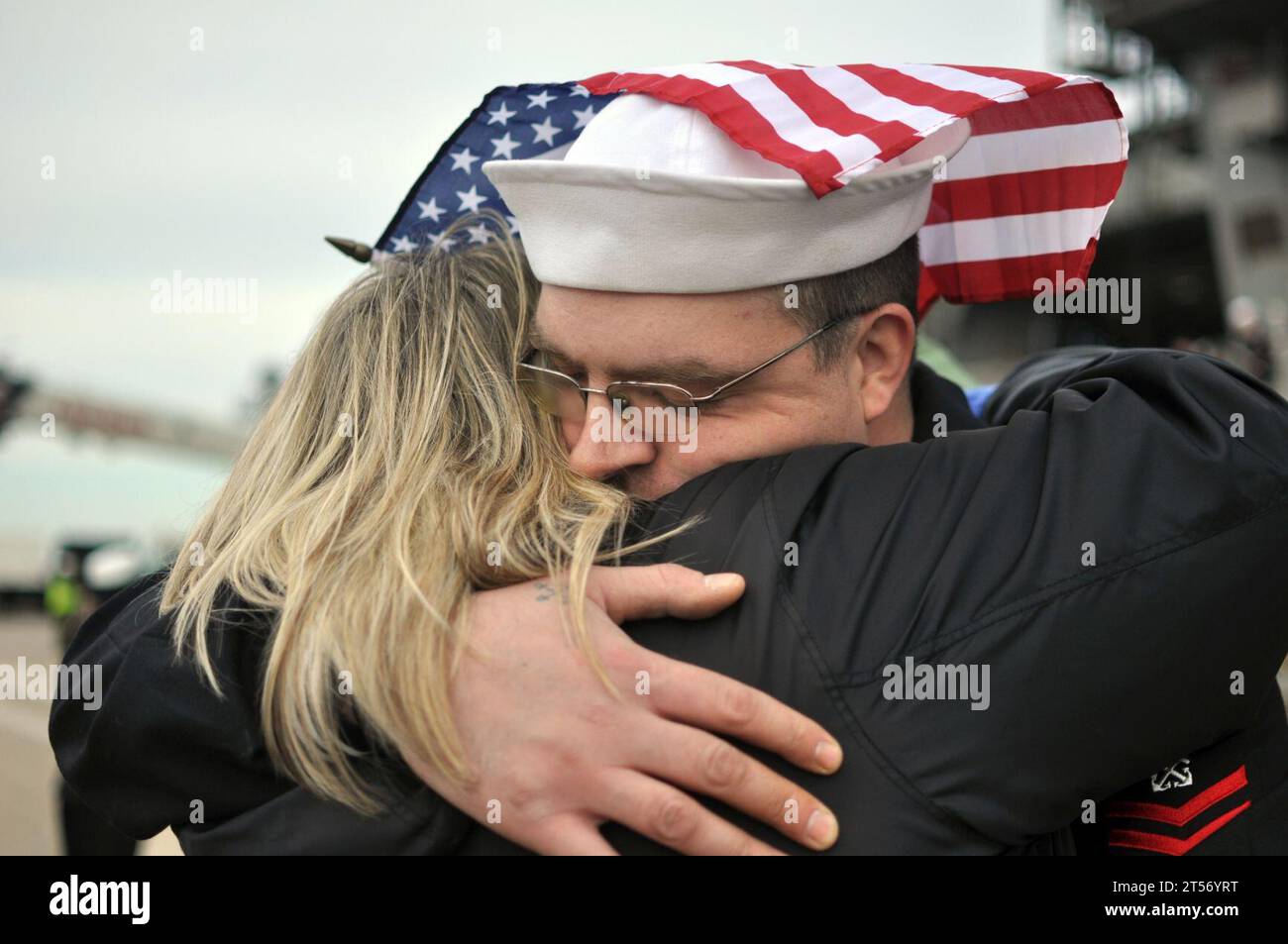 US Navy A Sailor hugs his wife following the ship's return to Naval ...