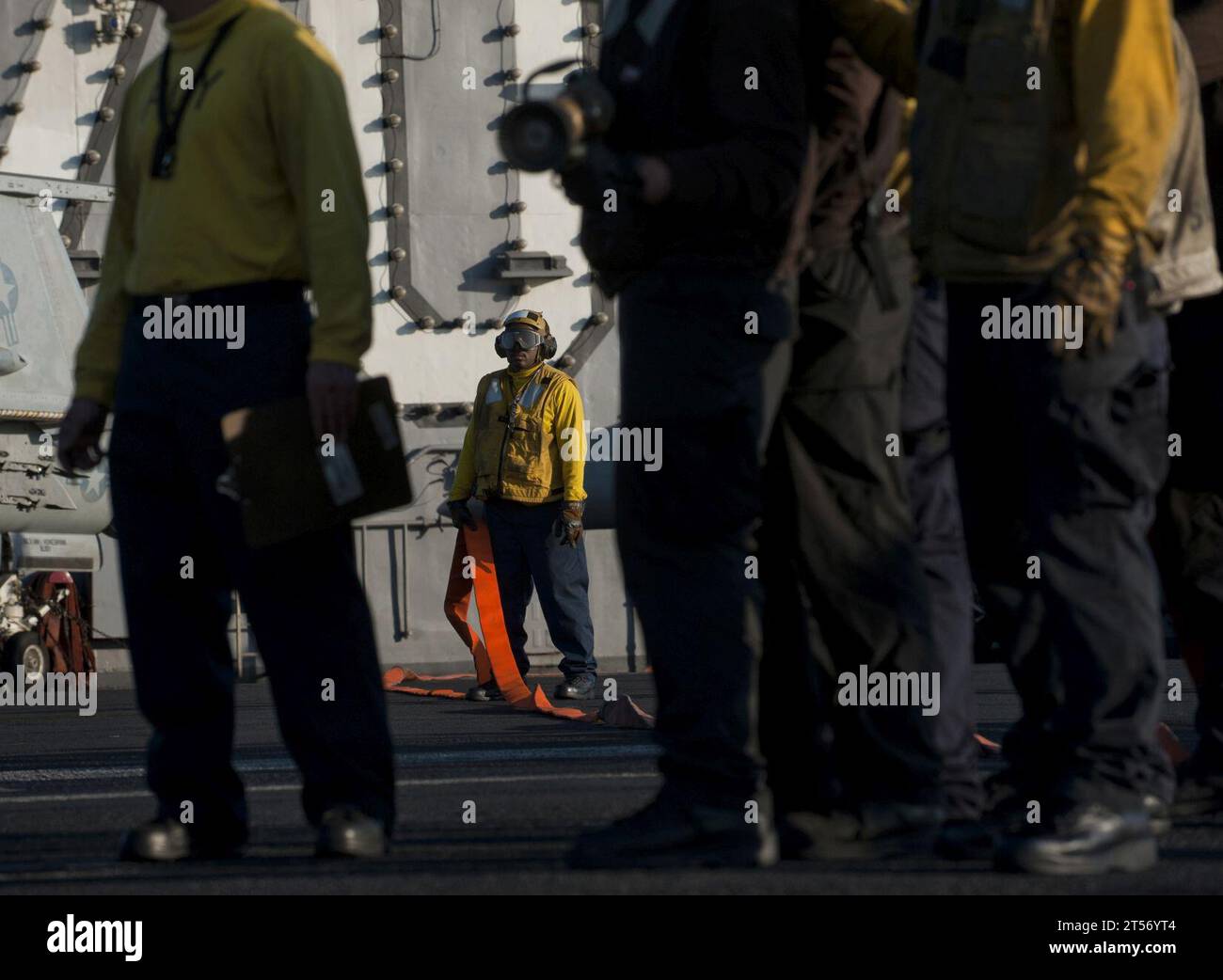 US Navy A Sailor mans a hose during a flight deck firefighting drill ...