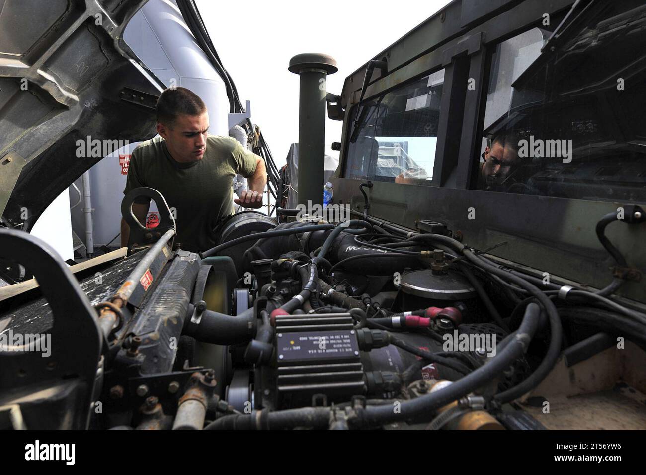 US Navy A Sailor performs maintenance on a Humvee.jpg Stock Photo - Alamy