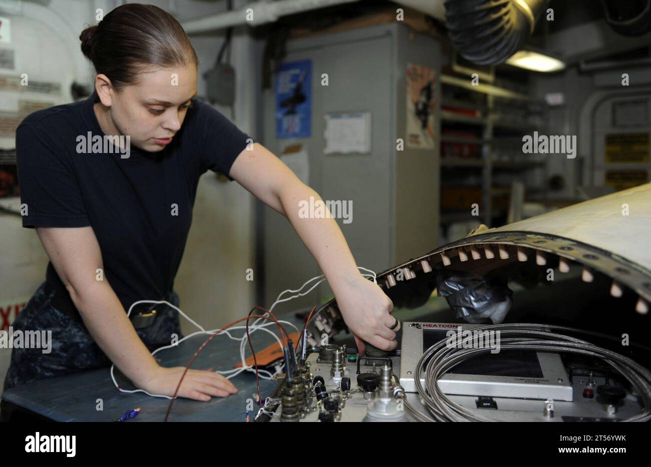 US Navy A Sailor performs a visual inspection on a jet bay door. brake ...