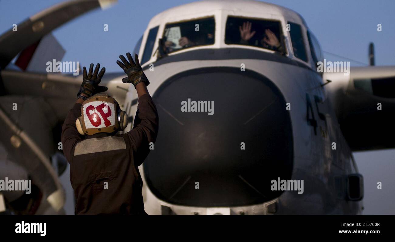 US Navy A Sailor signals to the pilots of a C-2A Greyhound assigned to ...