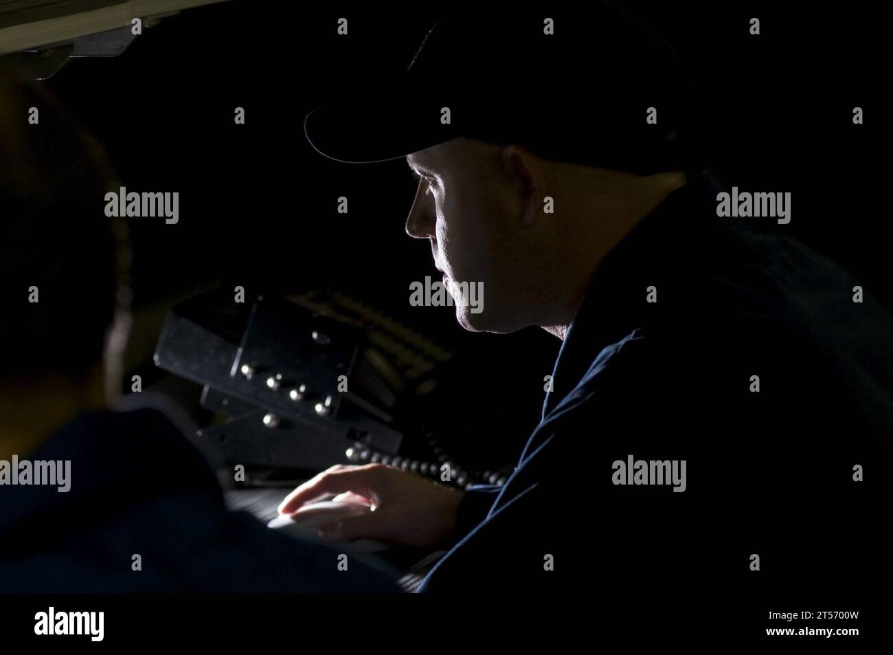 US Navy A Sailor reviews strike group assets in sea combat commander ...