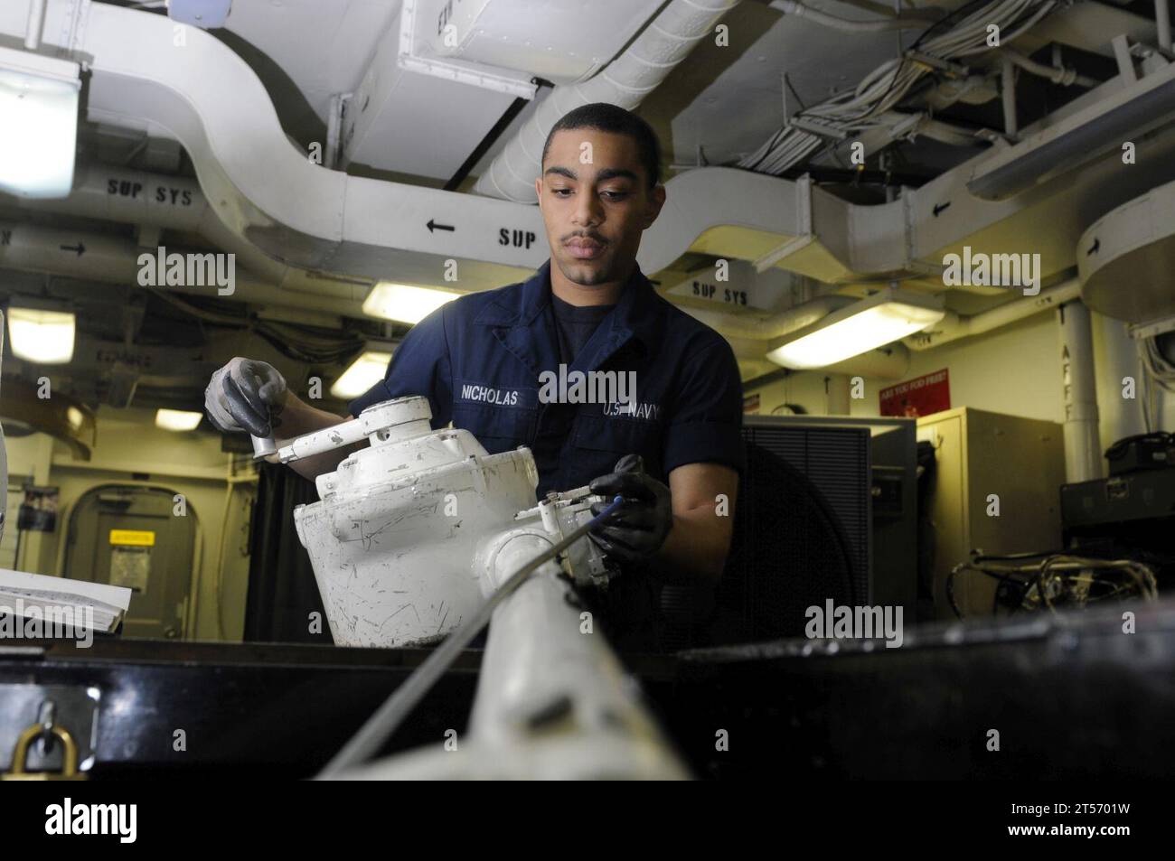 US Navy A Sailor reels in the load cable of a bomb hoist.jpg Stock ...
