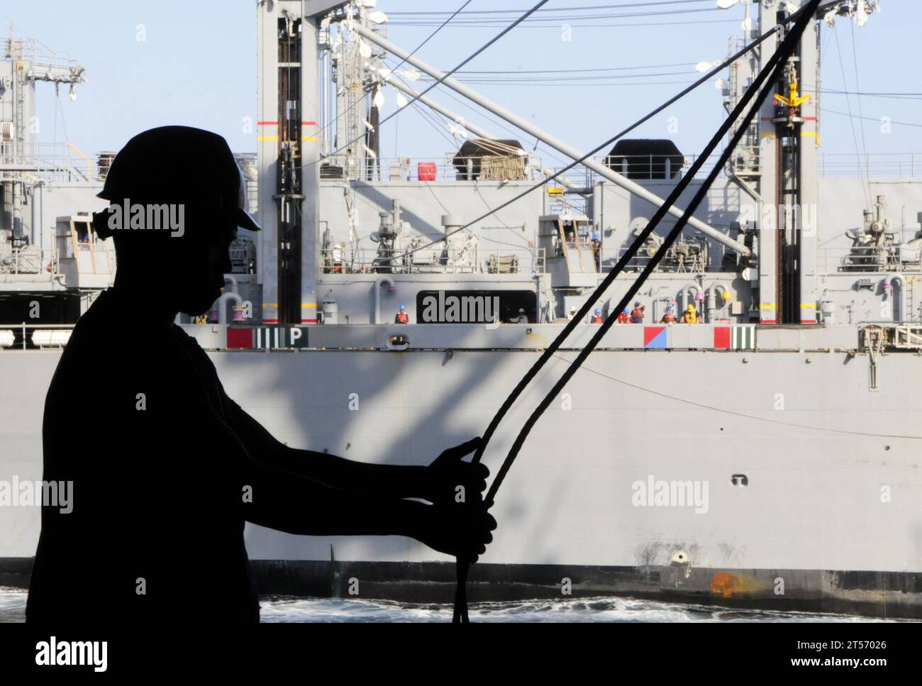 US Navy A Sailor rigs lines before transporting cargo via sliding ...