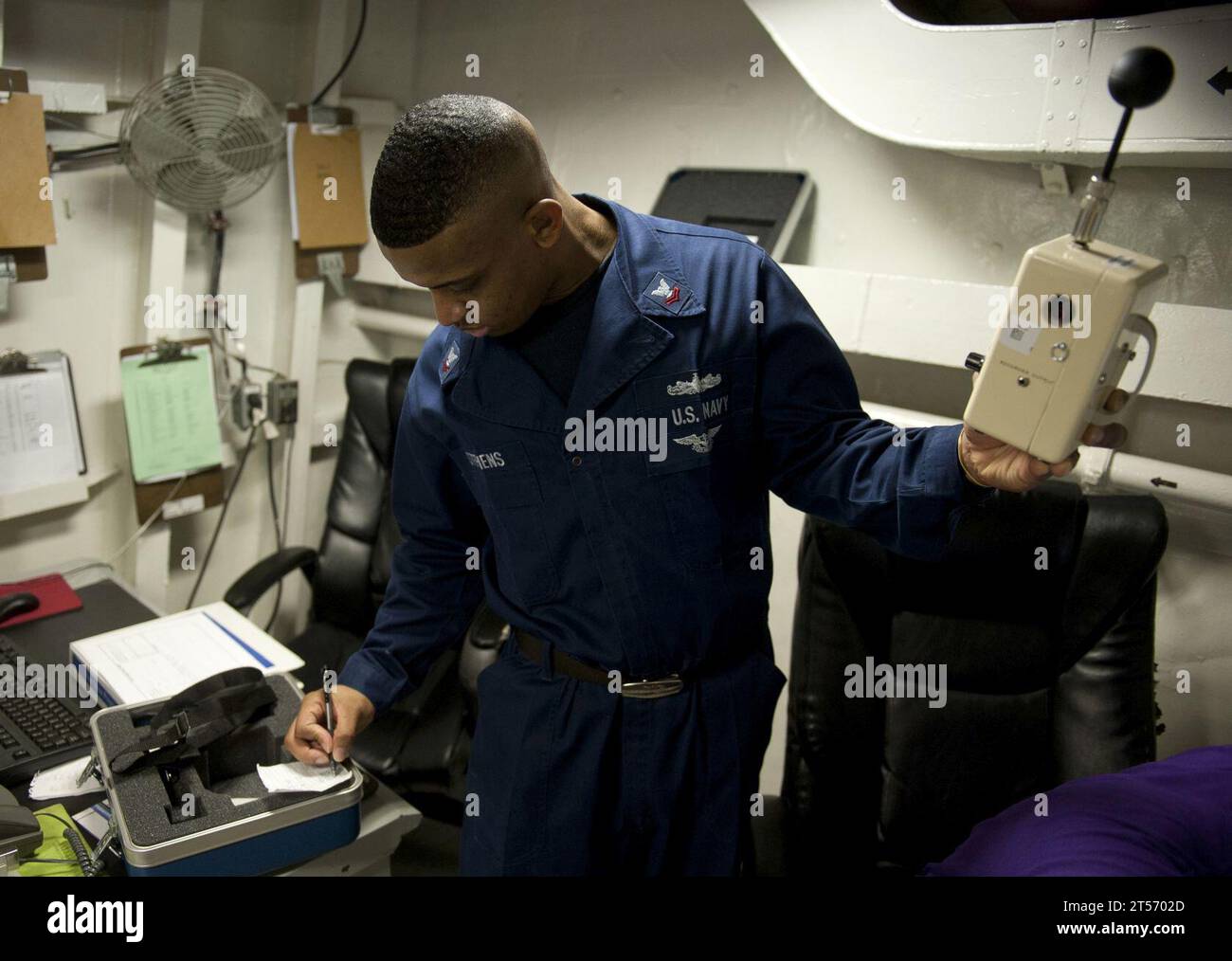 US Navy A Sailor records data from a heat stress monitor to measure ...