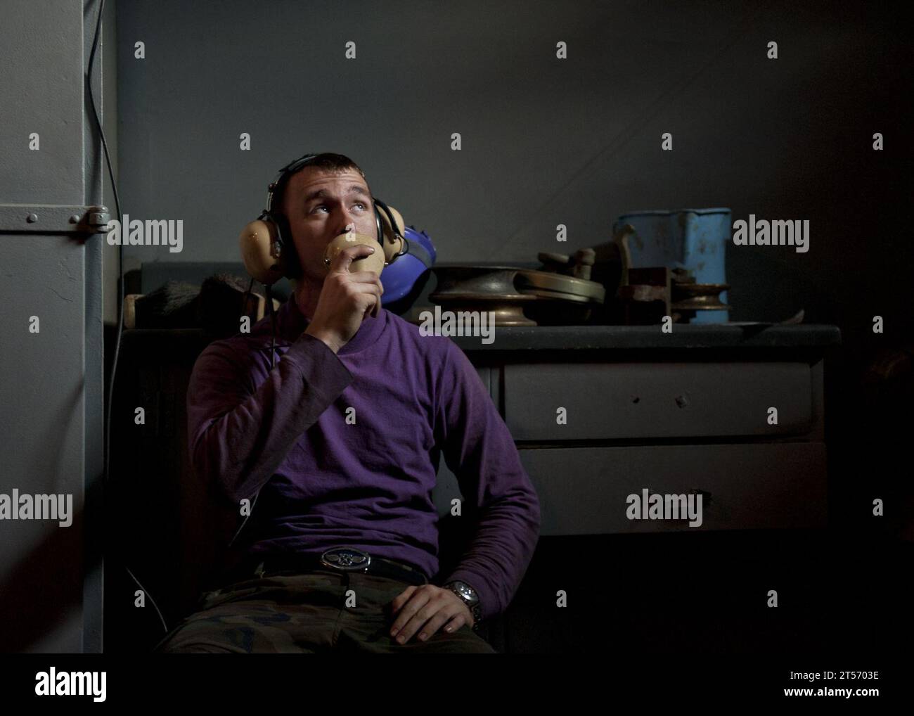 US Navy A Sailor uses a sound-powered telephone during a fueling at sea ...