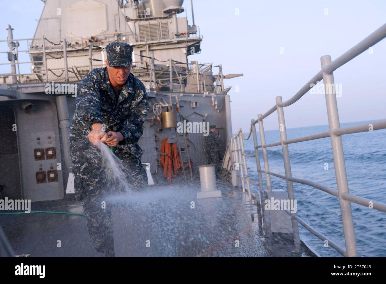 US Navy A Sailor washes the fantail of USS Cape St. George.jpg Stock ...