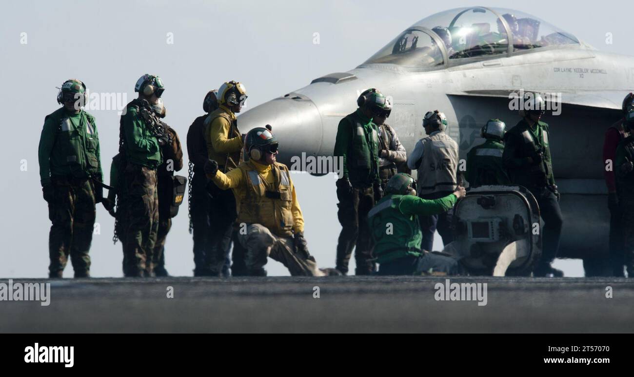 US Navy A shooter signals for the launching of a fixed wing aircraft on ...
