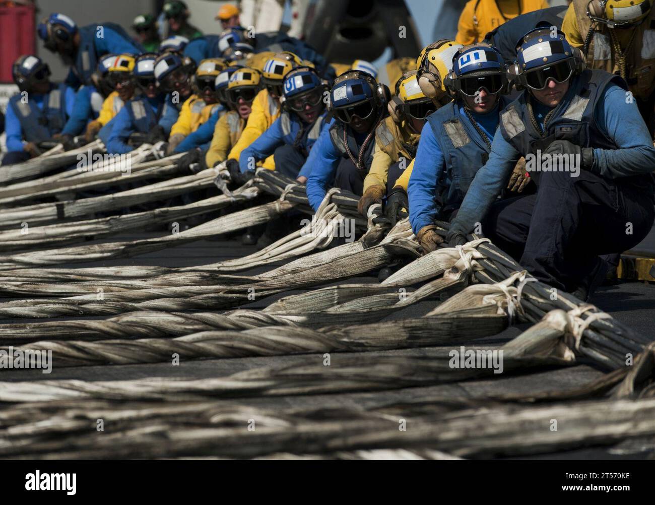 US Navy Air Department Sailors rig barricades during flight deck drills ...