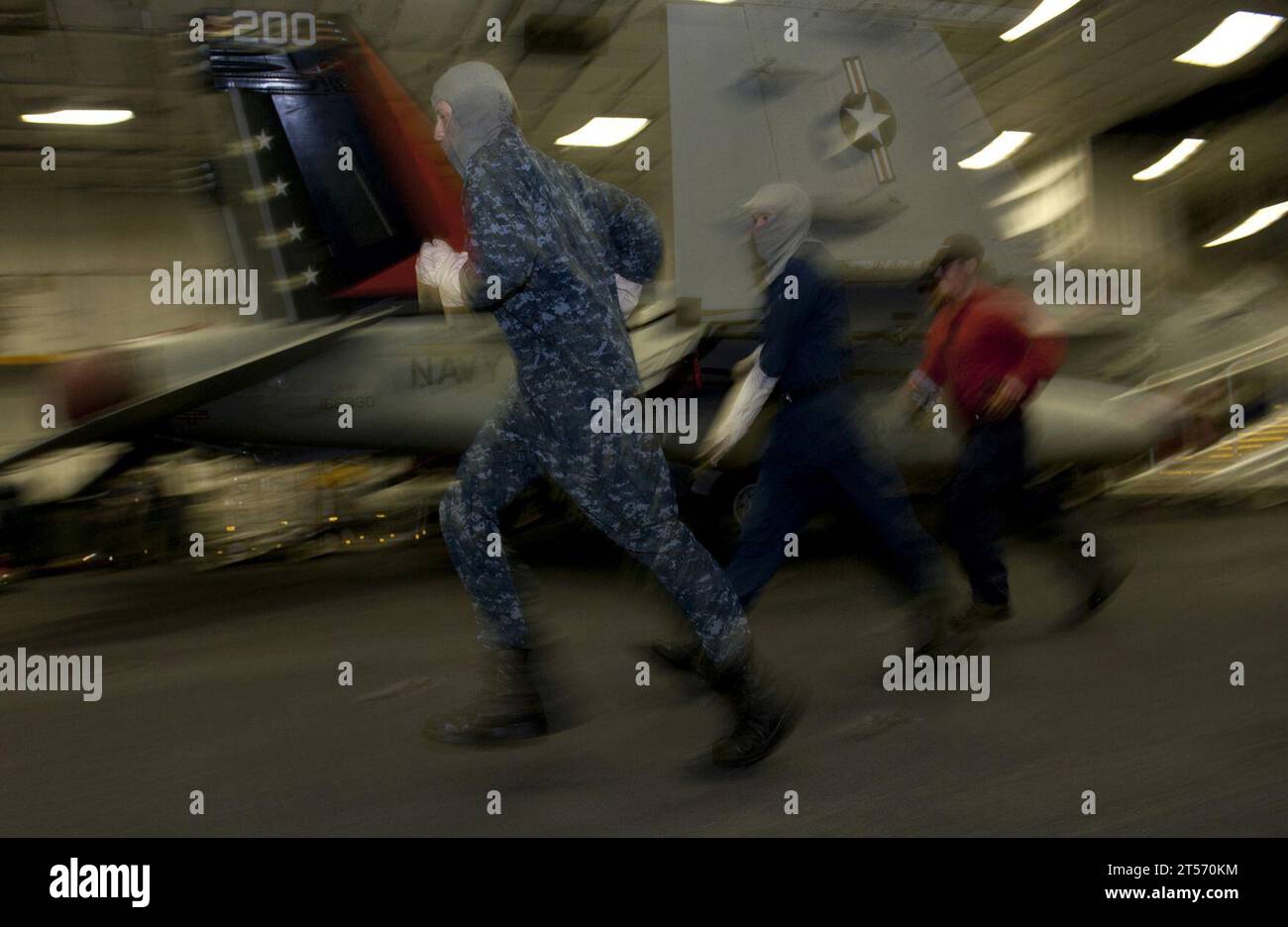 US Navy ailors run to their battle stations as an unscheduled general ...