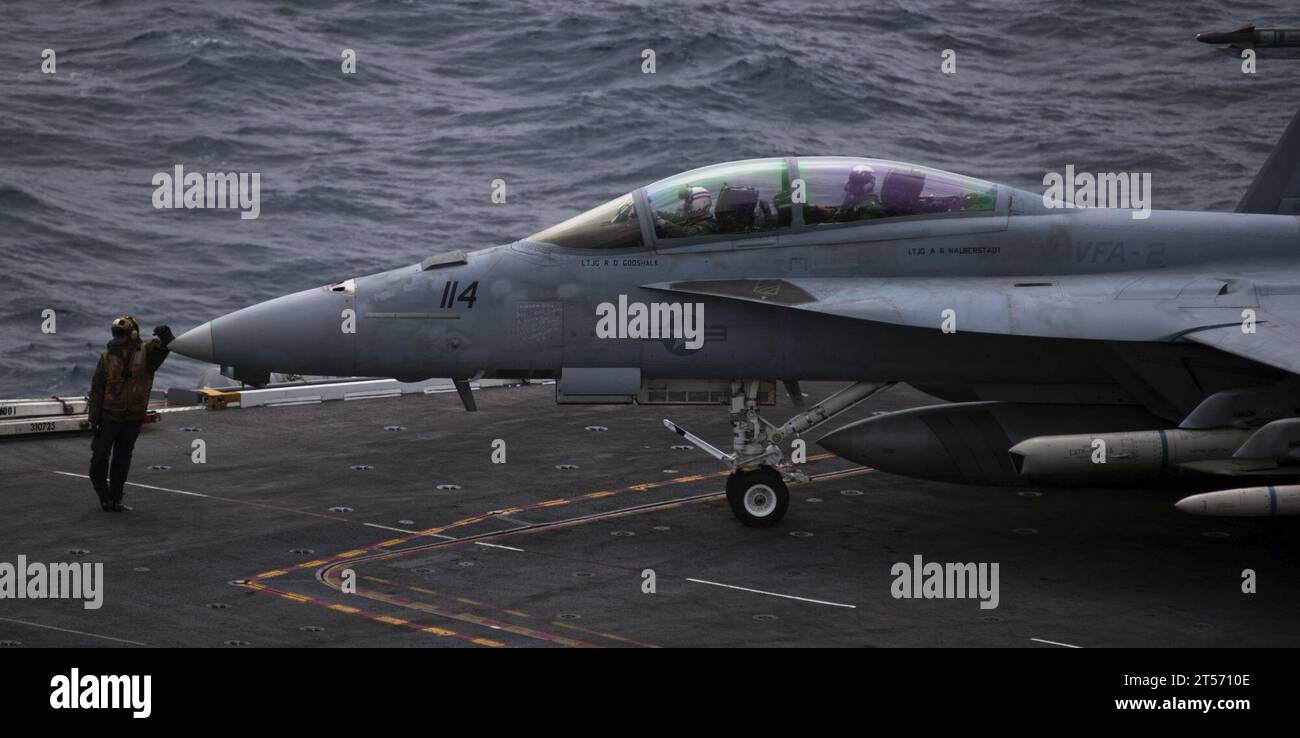 US Navy An aircraft director leans against an F18F Super Hornet ...
