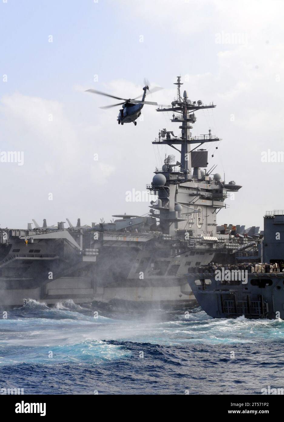 US Navy An MH-60S Knight Hawk helicopter transfers supplies from the ...