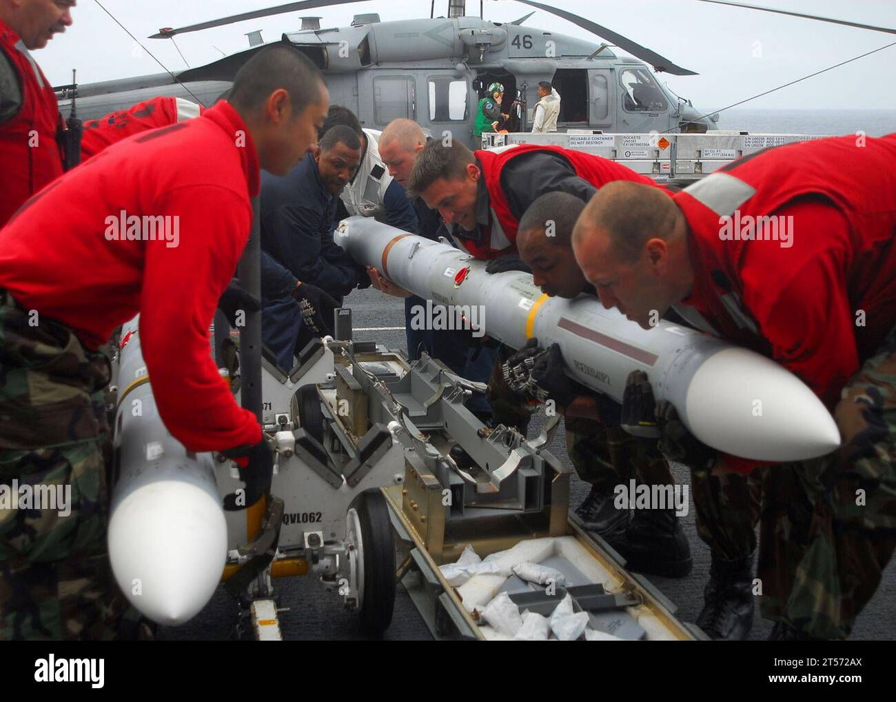 US Navy Aviation ordnancemen move missiles from the flight deck to the ...