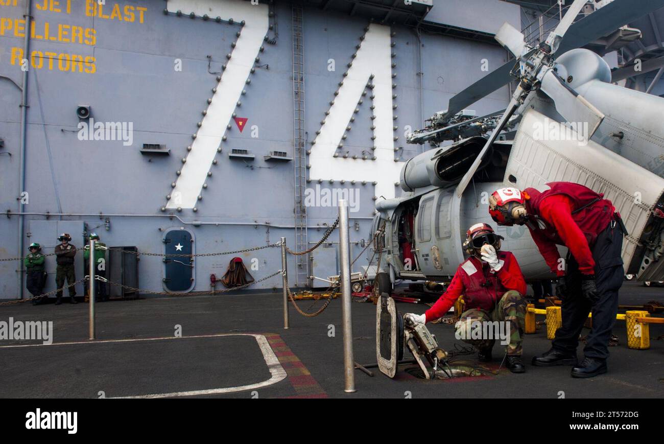 US Navy Aviation ordnancemen perform a communications check from a ...