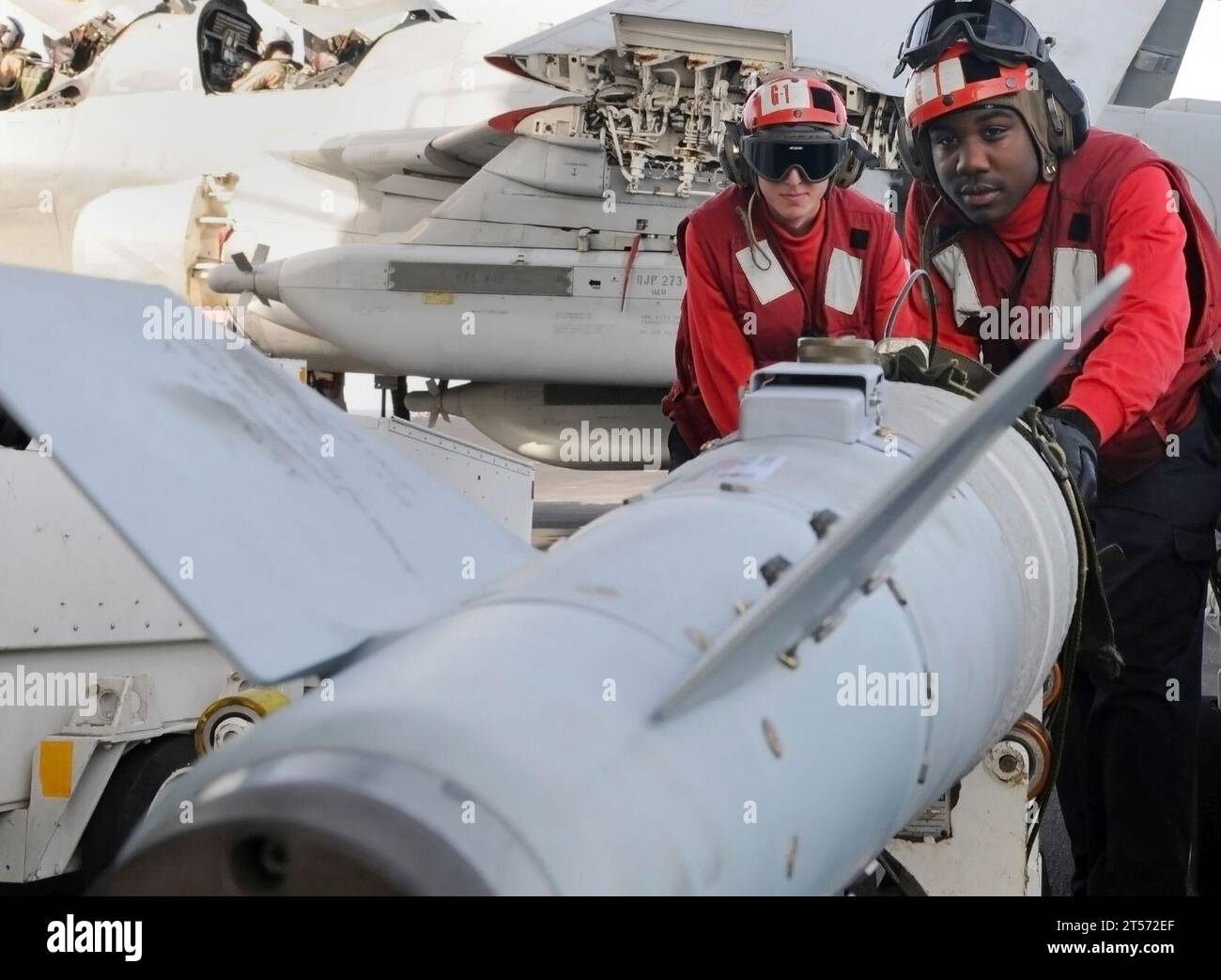 US Navy Aviation ordnancemen move ordnance on the flight deck of the ...