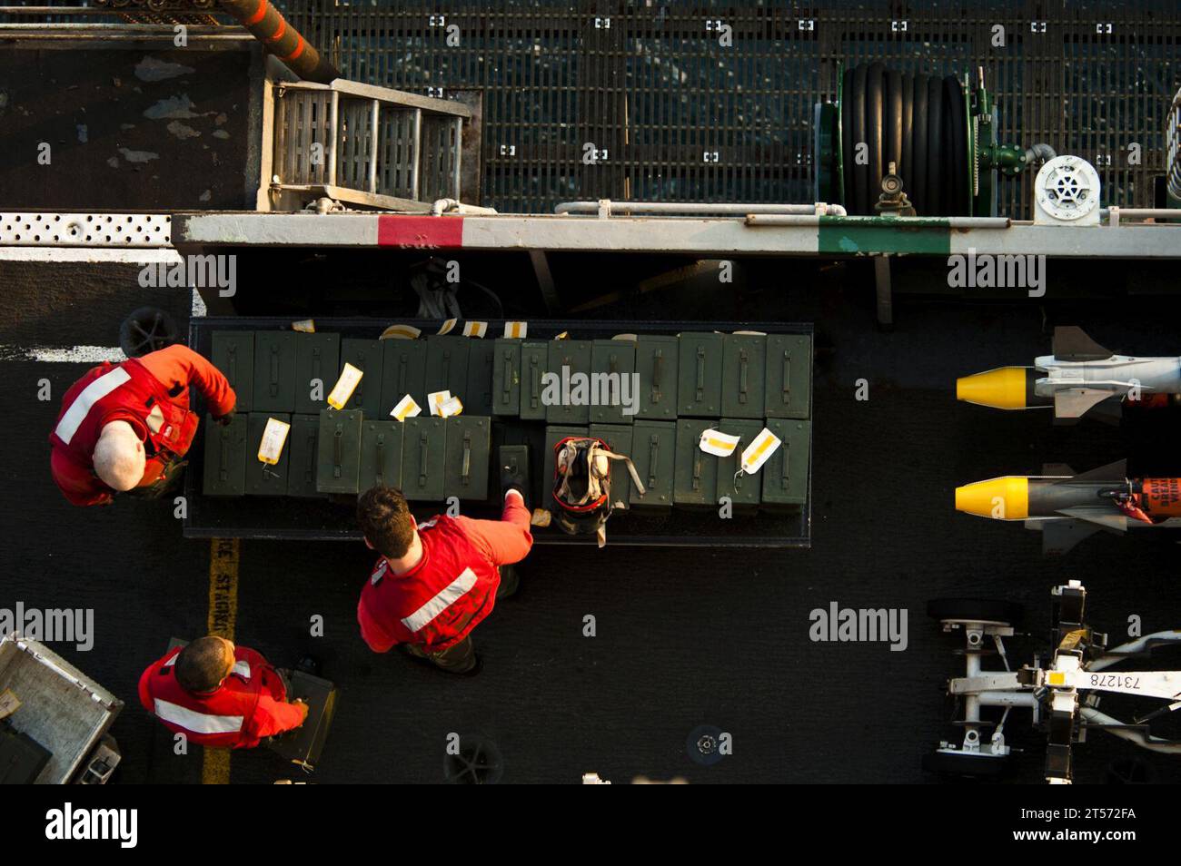 US Navy Aviation ordnancemen stack ammunition containers in the bomb ...