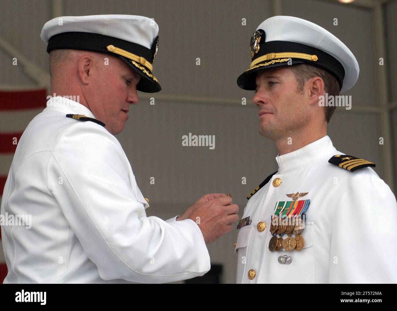 US Navy Cdr. John H. Hill, left, passes the command pin to his ...