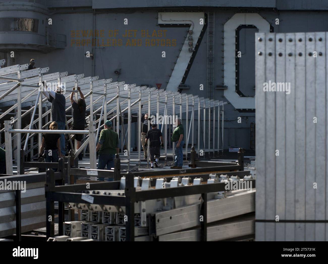 US Navy Civilian contractors assemble bleachers while building a ...