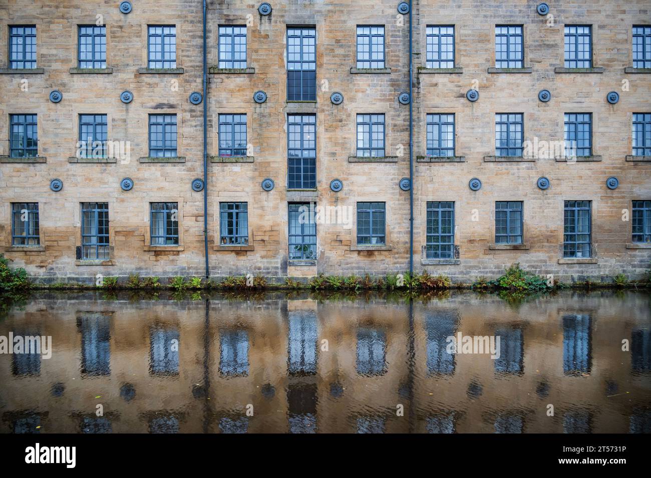 A disused mill has been converted to flats on the banks of the Rochdale ...