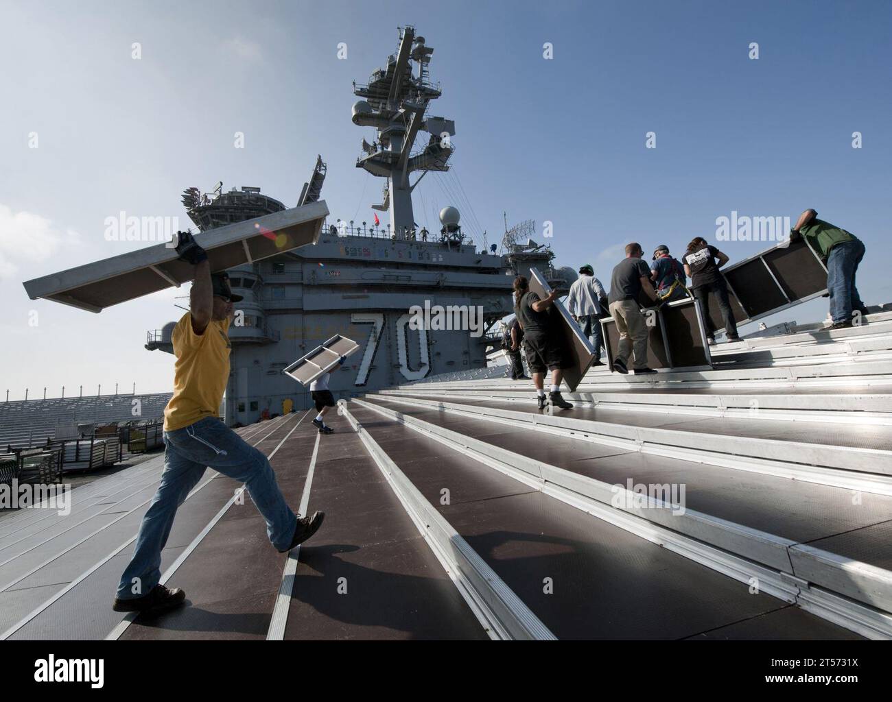US Navy Civilian contractors assemble bleachers while building a ...