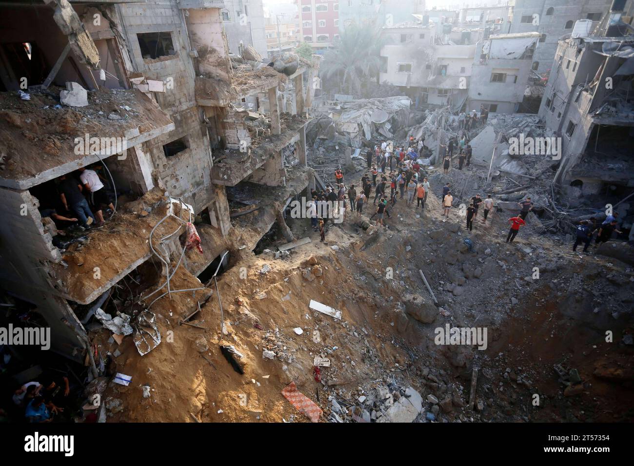 Palestinians conduct a search and rescue operation after the attack of ...