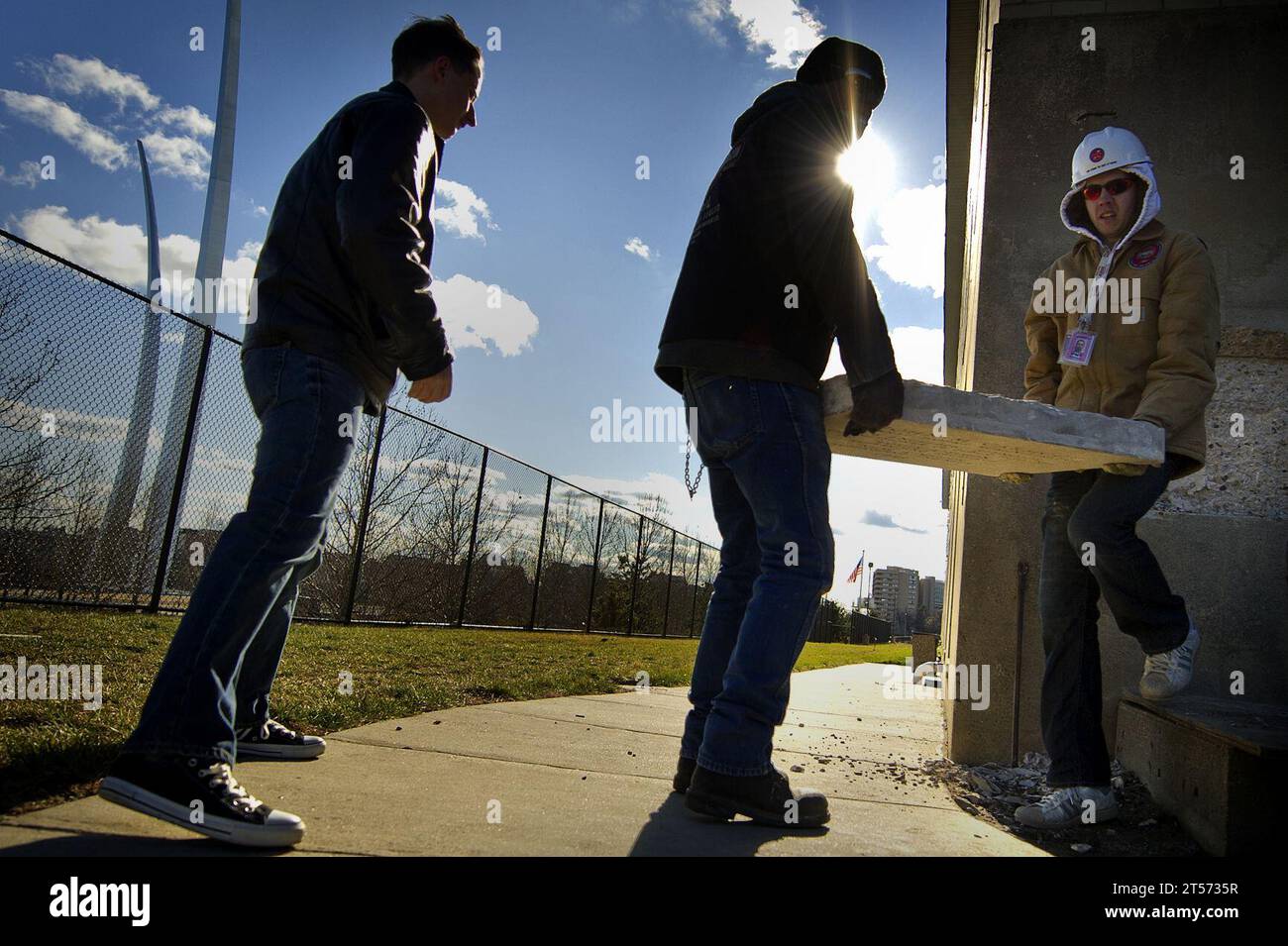 US Navy Contractors carry away a cornerstone located at the Navy Annex ...