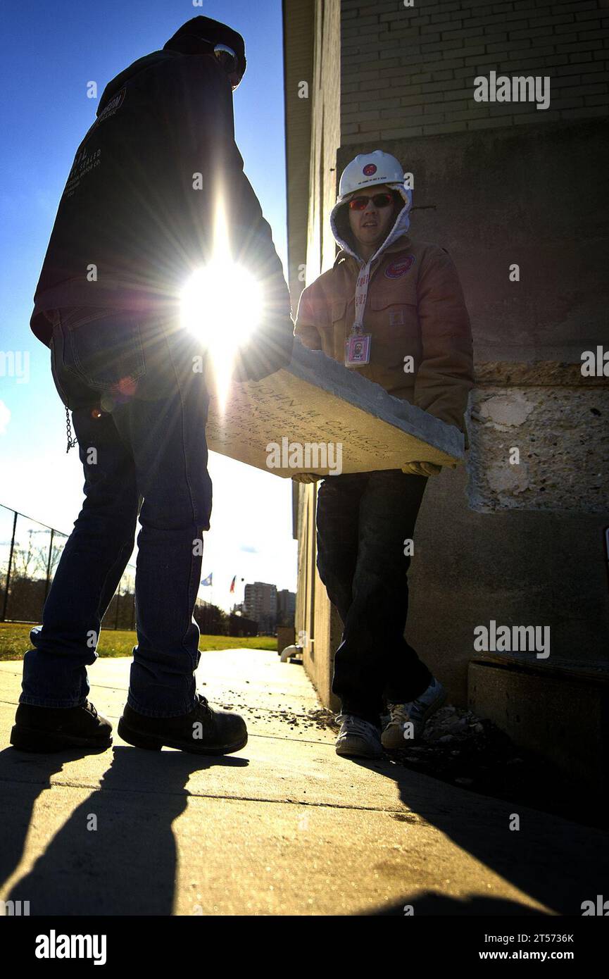 US Navy Contractors carry away the cornerstone located at the Navy ...