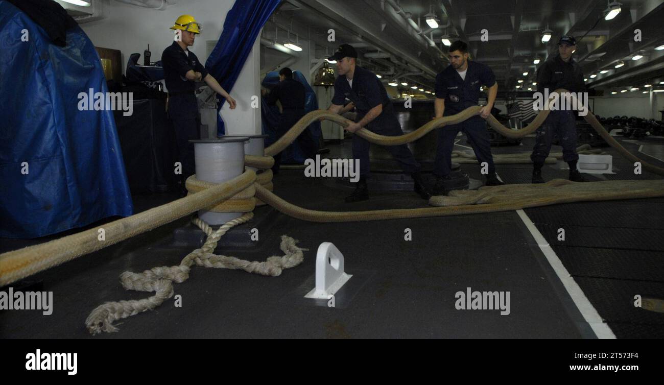 US Navy Deck department Sailors heave mooring lines in the forecastle ...