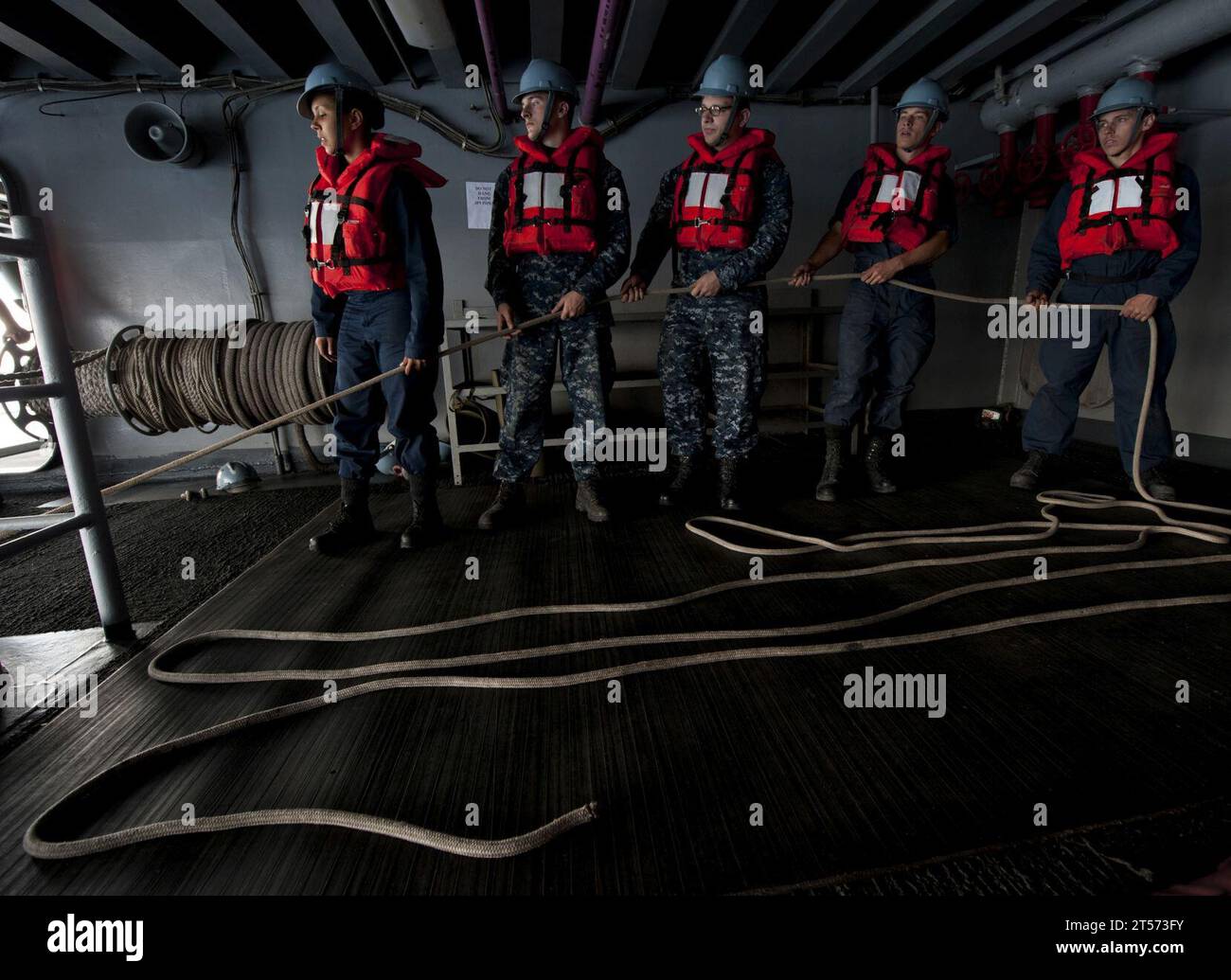US Navy Deck department Sailors recover a rigid hull inflatable boat ...