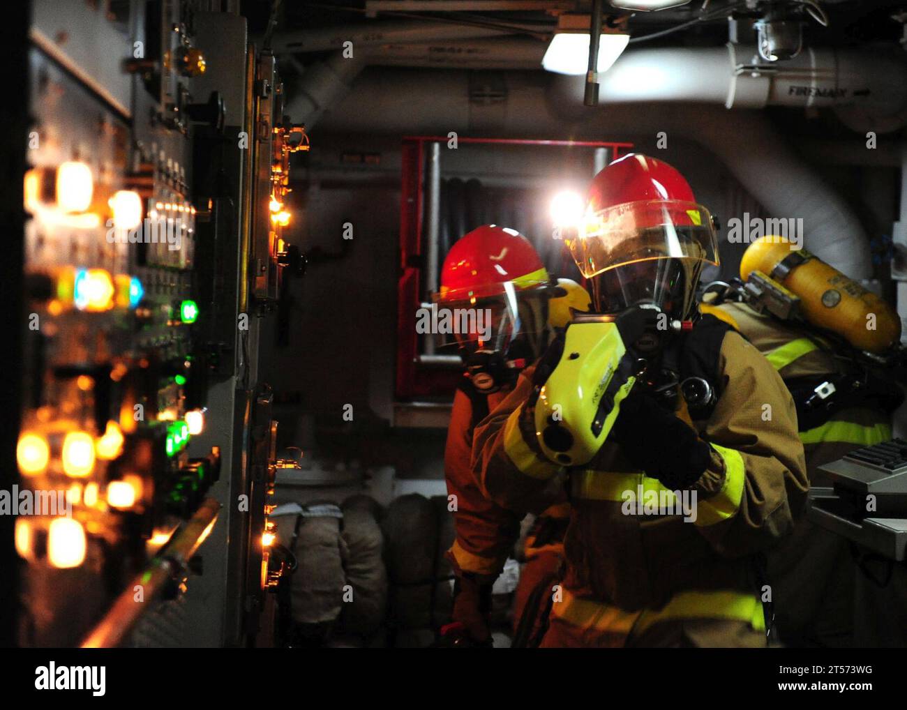 US Navy Fire assessment members use a naval firefighting thermal imager ...