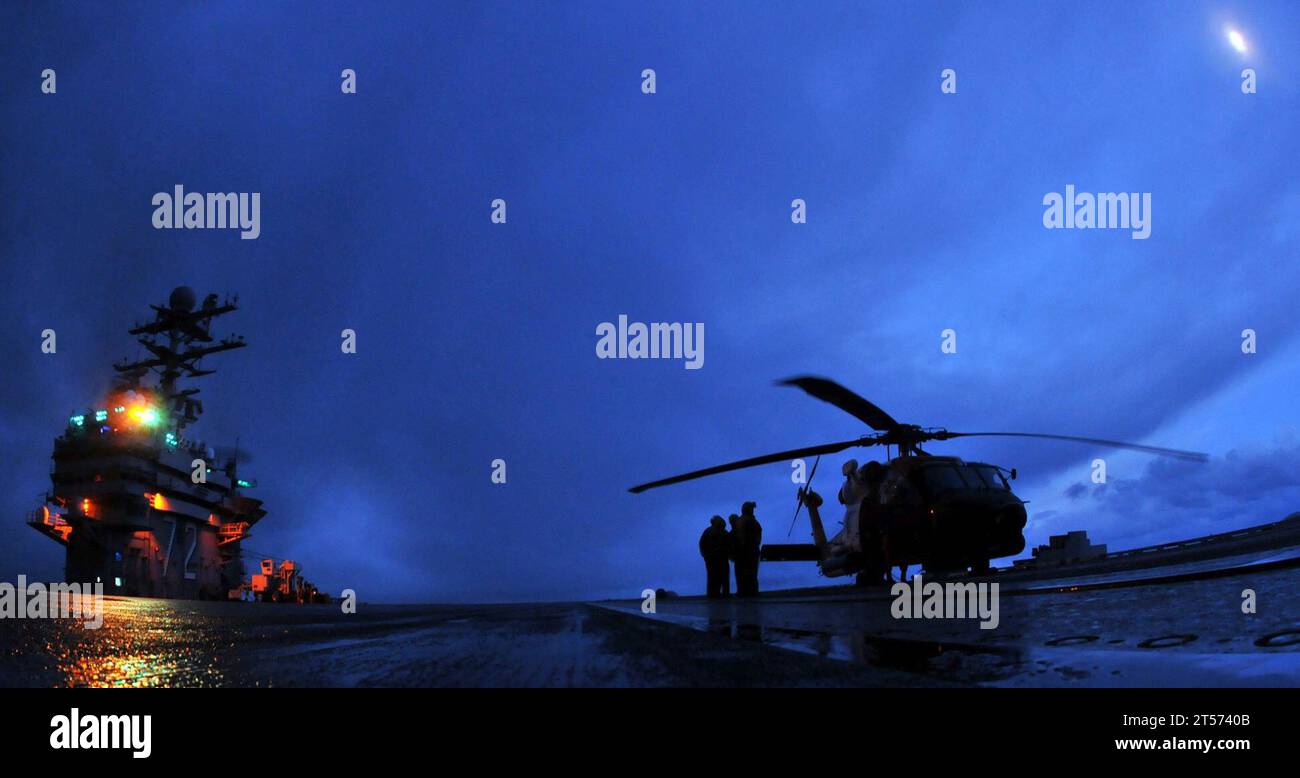 US Navy Flight deck personnel ready a San Diego Coast Guard HH-60 for ...