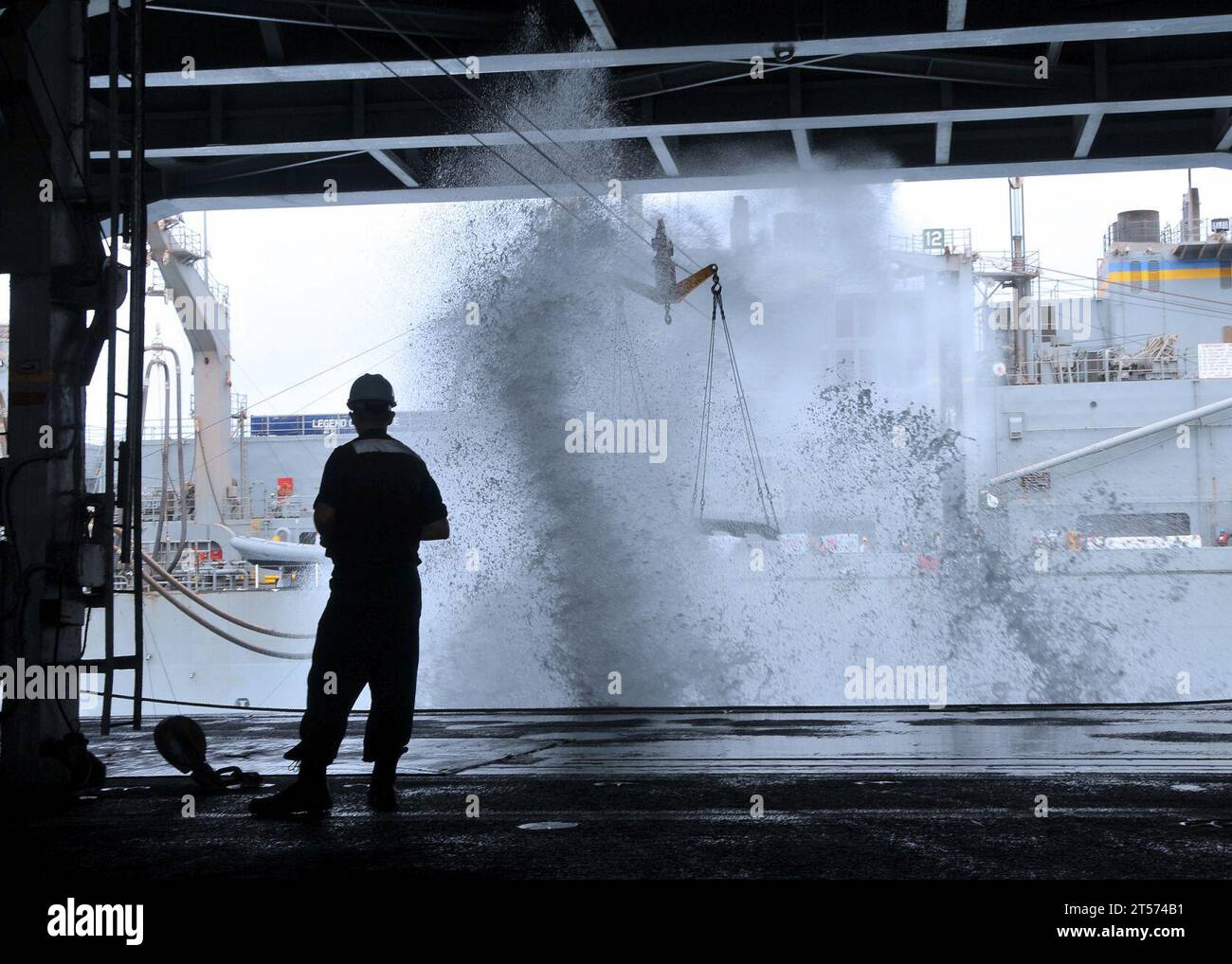 US Navy High seas splash upon the hangar deck of the Nimitz-class ...