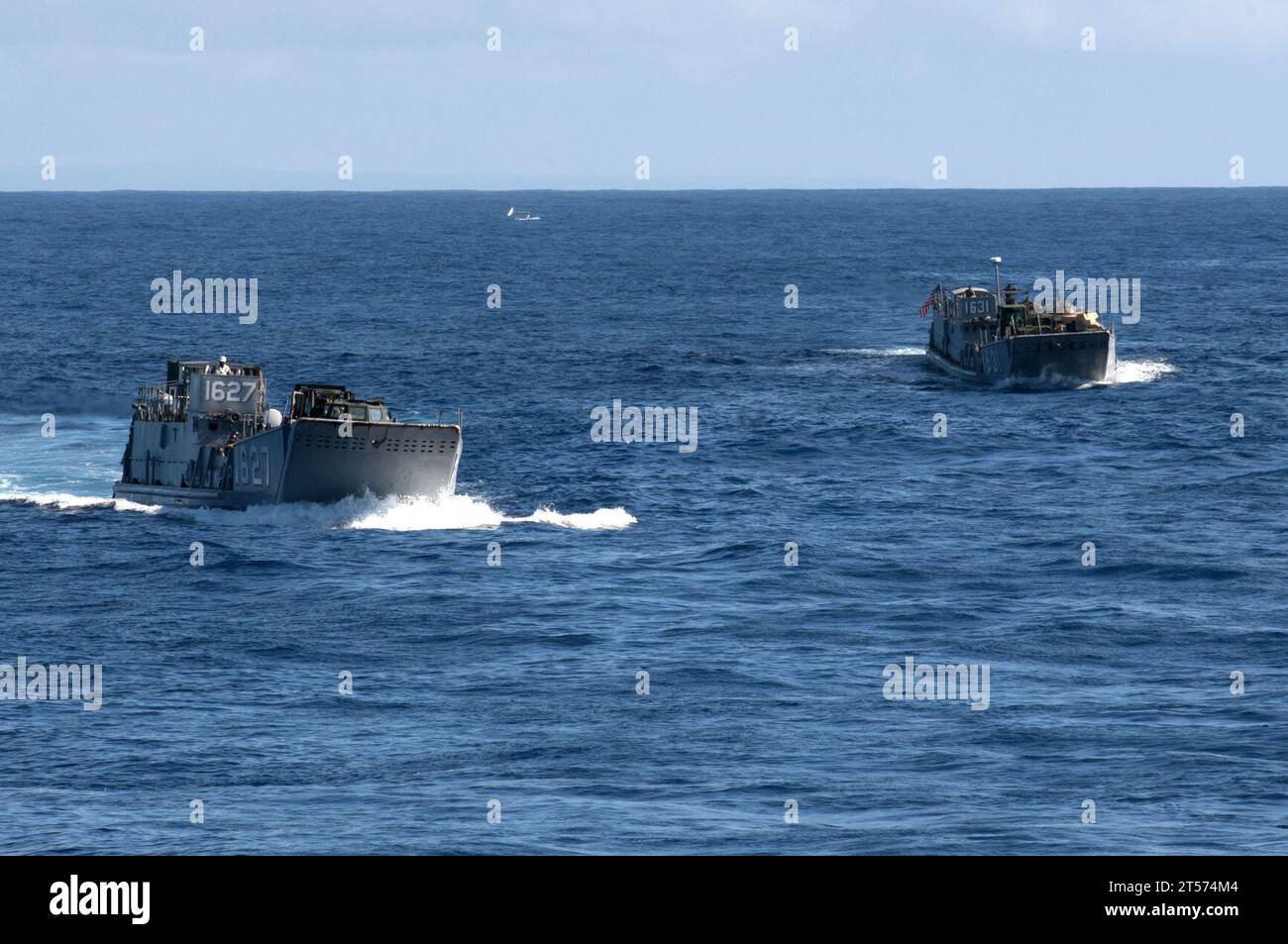 US Navy Landing Craft Utilities 1627 and 1631 prepare to enter the well ...