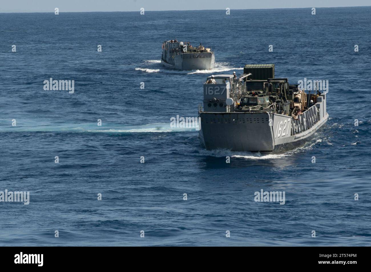 US Navy Landing Craft Utilities 1627 and 1631 prepare to enter the well ...