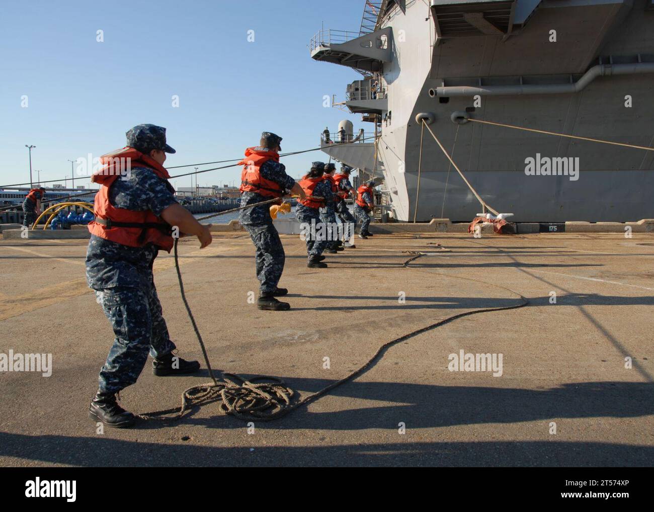 US Navy Line handlers secure the aircraft carrier USS Dwight D ...