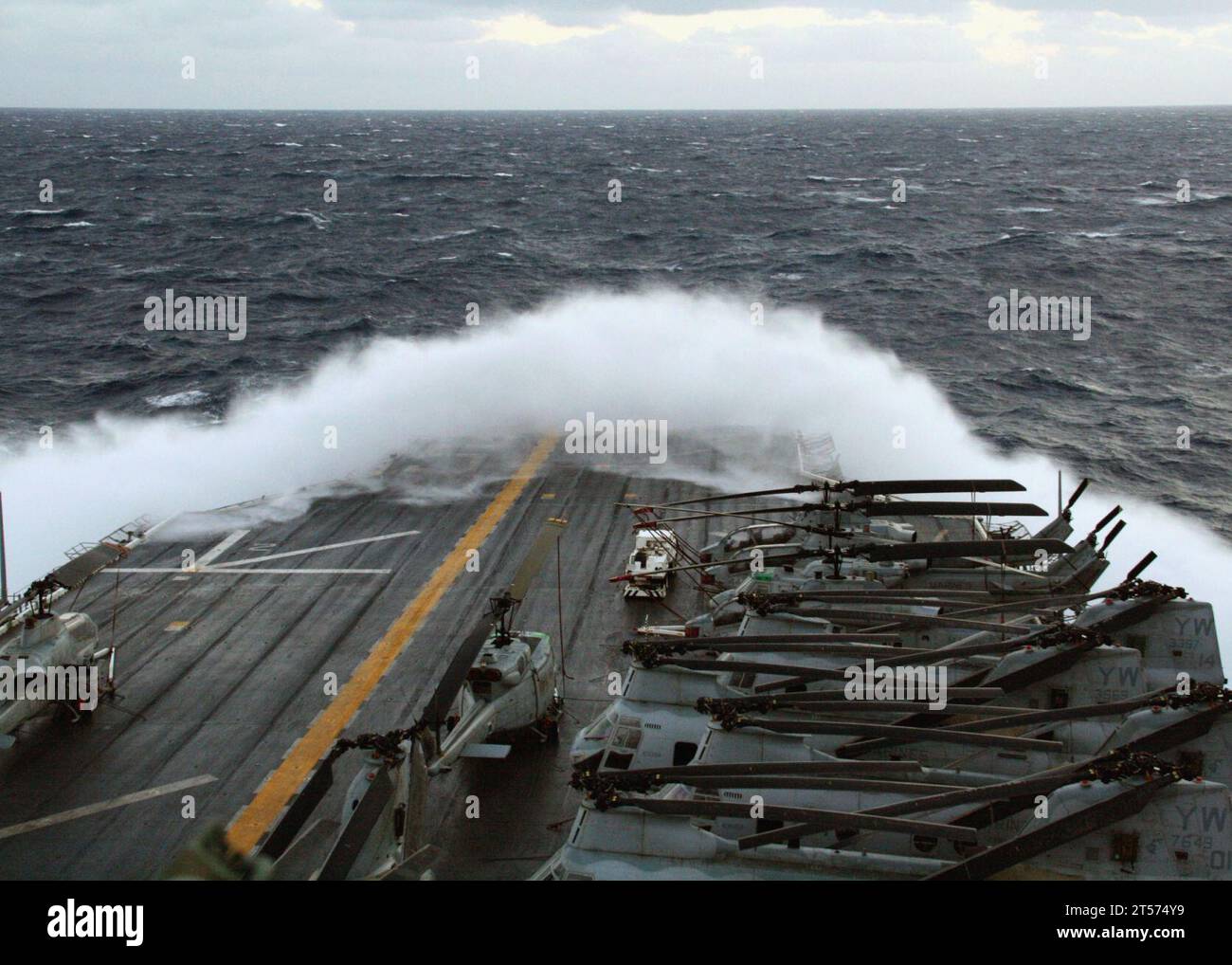 US Navy Large waves create sea spray over the bow of the amphibious ...