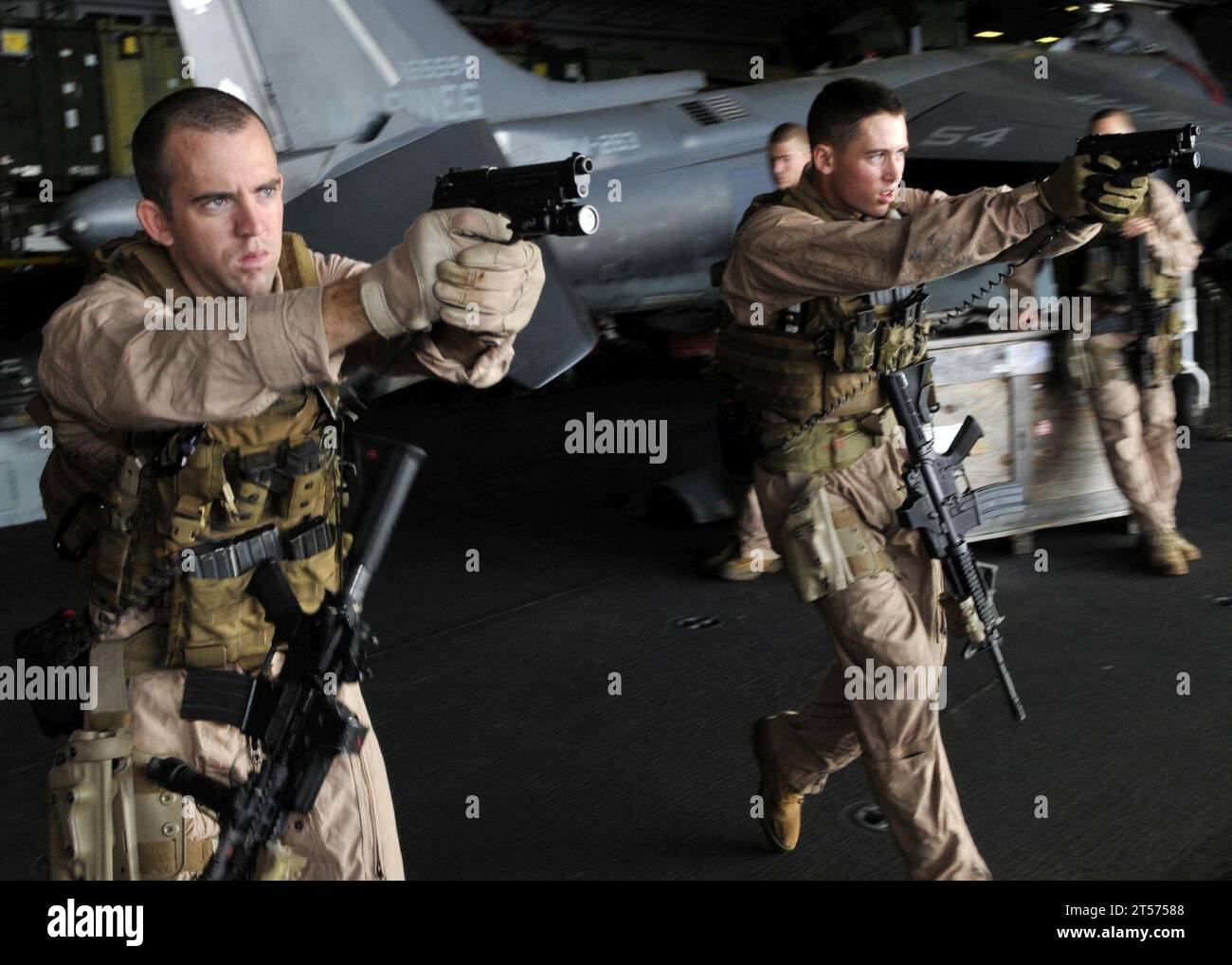 US Navy Marines perform weapon transition drills in the hangar bay ...