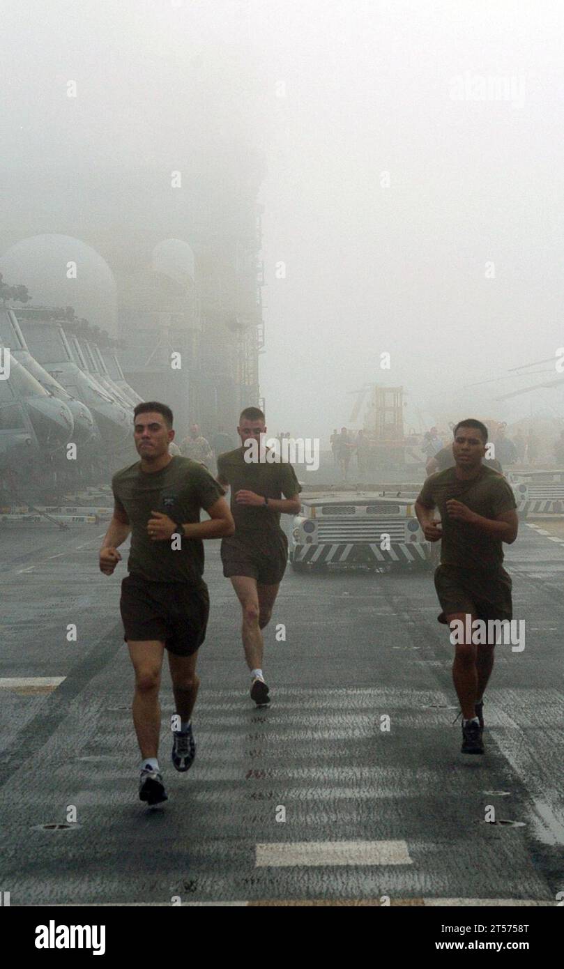 US Navy Marines from the 11th Marine Expeditionary Unit jog through the ...