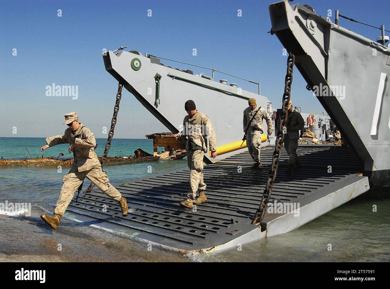 US Navy Marines of the 11th Marine Expeditionary Unit debark from a ...